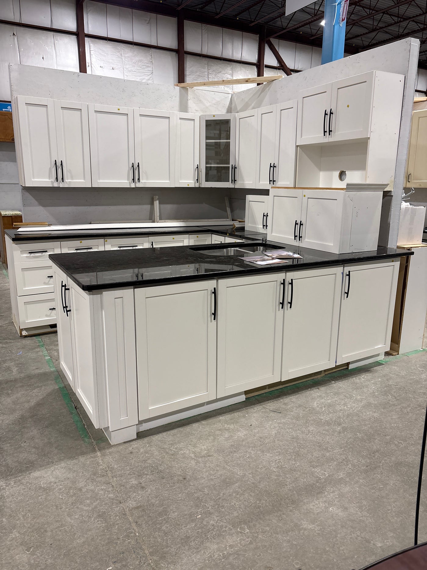 White Shaker Raised Panel Kitchen with Black Hardware and Black Quartz ...
